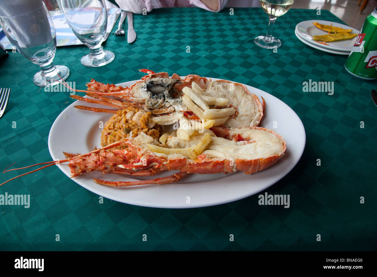 a plate of cooked lobster, fries and rice Stock Photo - Alamy