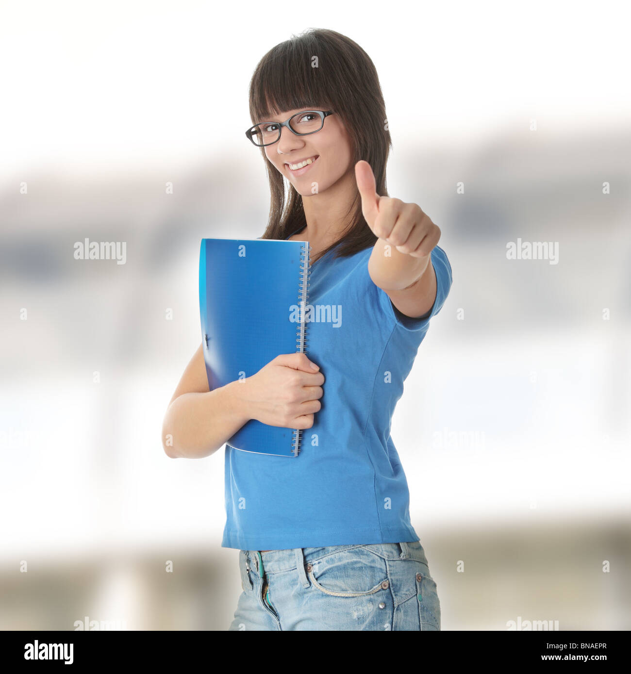 Teen student girl with note pad gesturing OK Stock Photo - Alamy