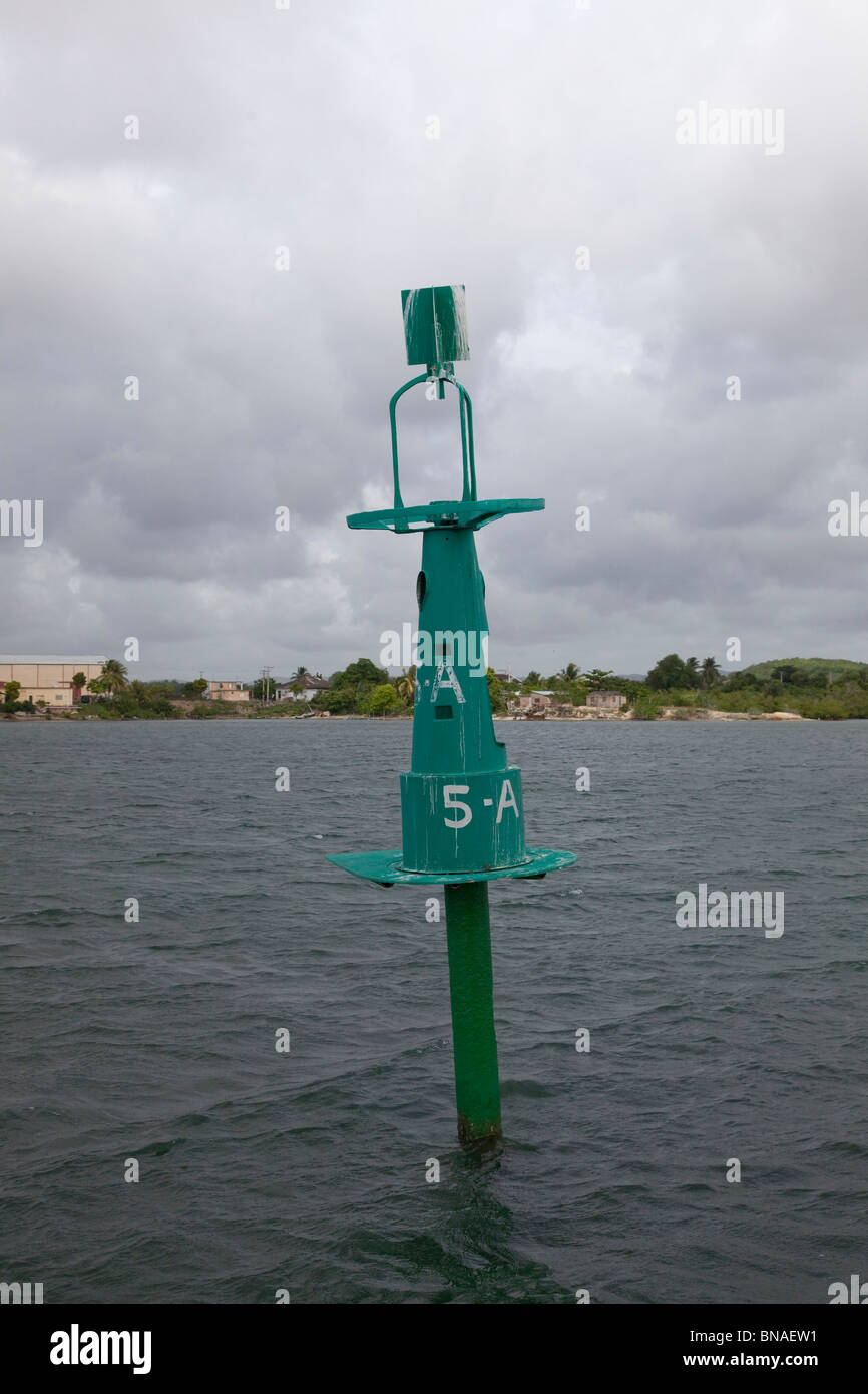 A green buoy close to coast Stock Photo - Alamy