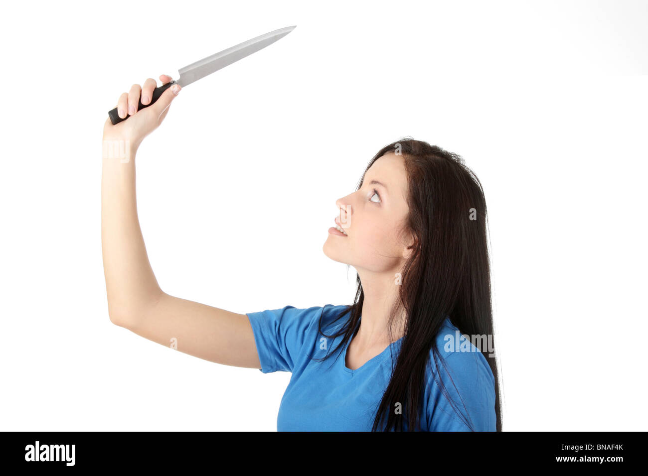 Young woman with big knife in hand - like she is cutting something in ...