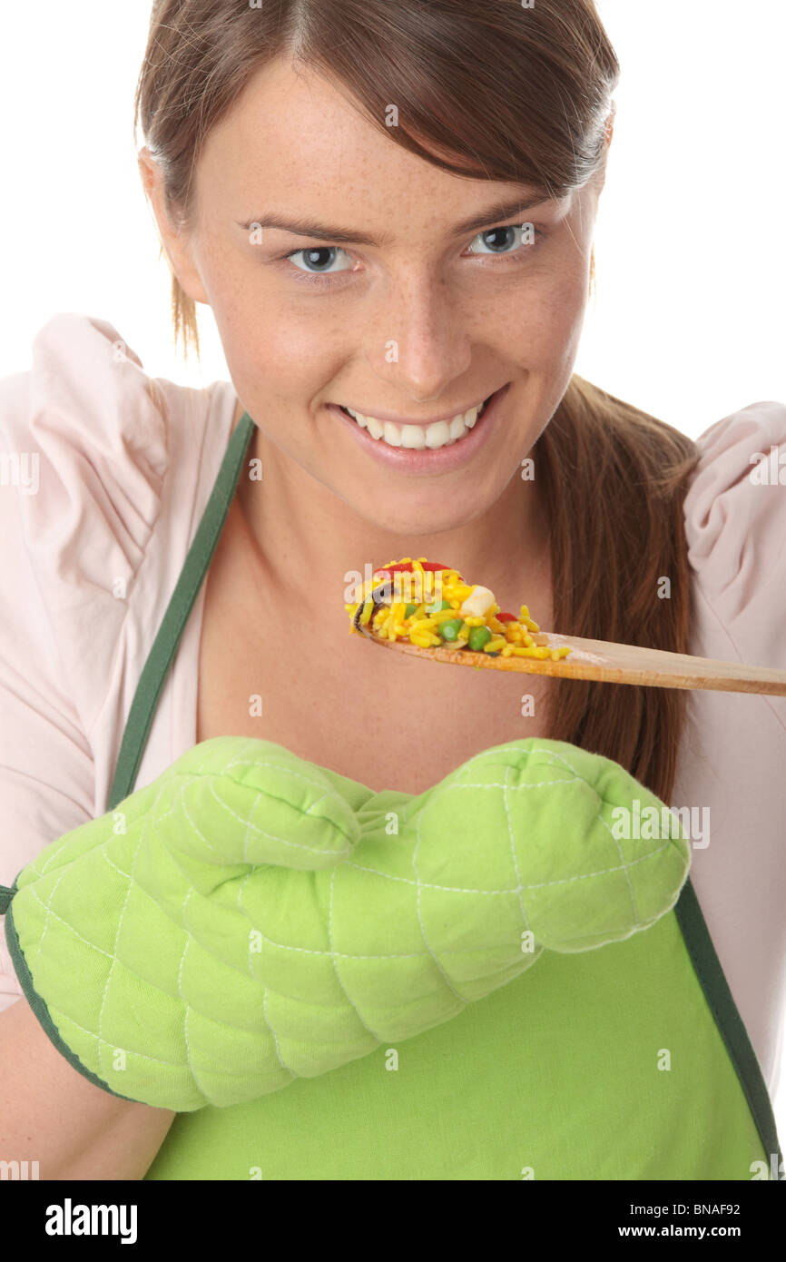 Beautiful young female cook tasting some food, isolated on white Stock ...