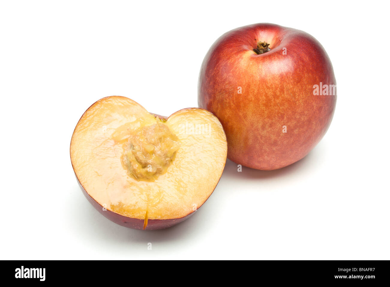 fresh vibrant Nectarine and slice with stone from low perspective ...