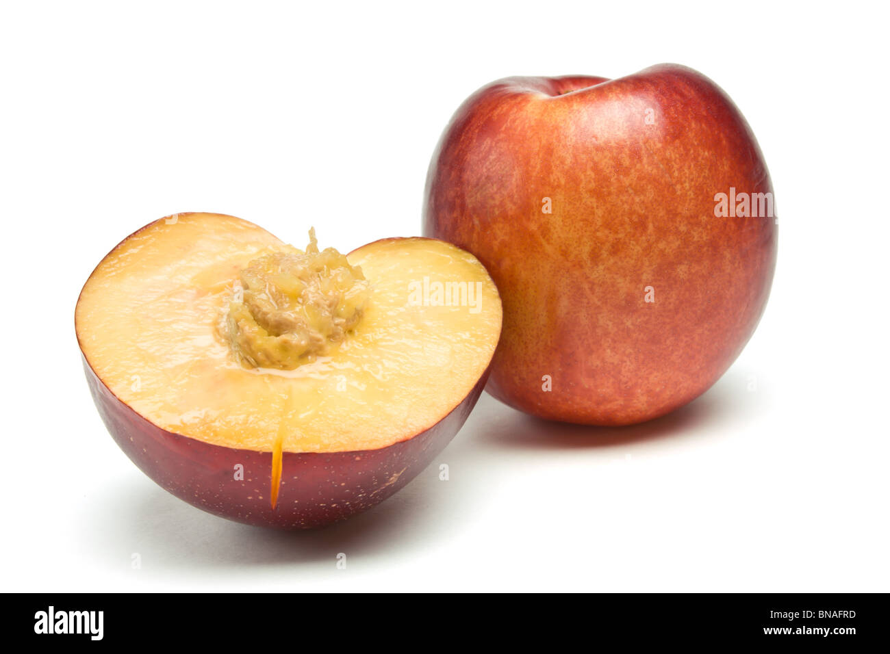 fresh vibrant Nectarine and slice with stone from low perspective ...