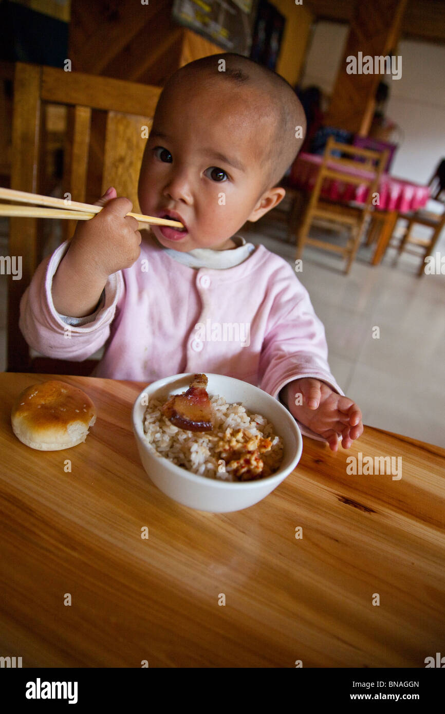 Child eating chopsticks hi-res stock photography and images - Alamy
