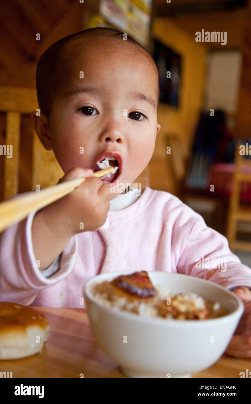 Cute chinese baby girl eating hi-res stock photography and images - Alamy