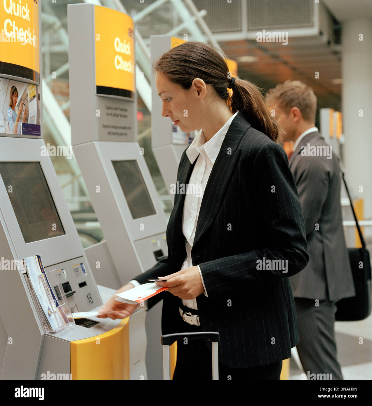 Business women checking in for flight Stock Photo - Alamy