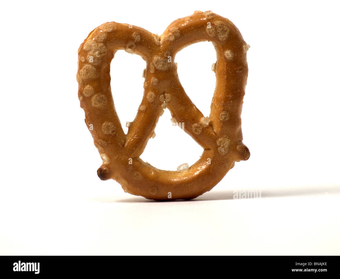 A pretzel isolated on a plain, white background Stock Photo - Alamy