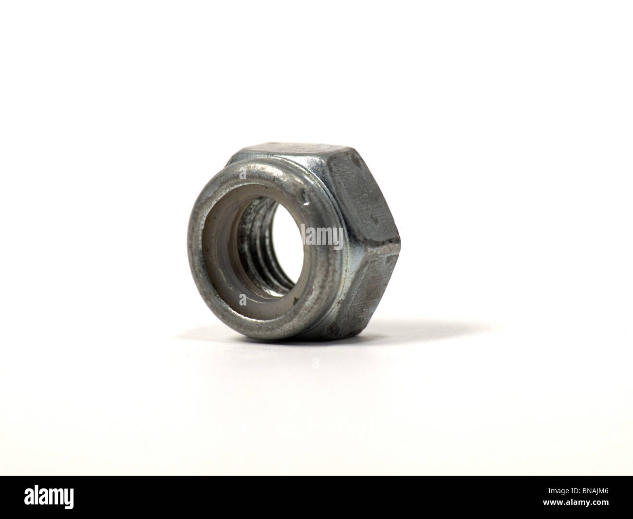 A single, steel nut isolated on a white background Stock Photo - Alamy