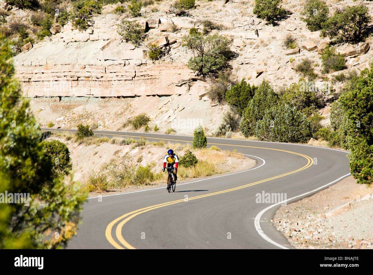 A biker rides the curves on the scenic Rim Rock Drive in Colorado ...