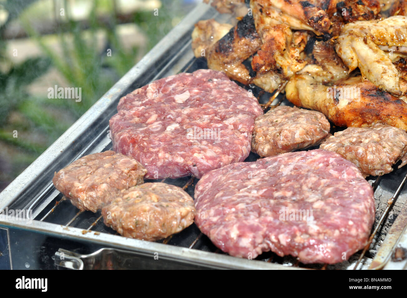 Raw meat on a barbecue before grilling Stock Photo - Alamy