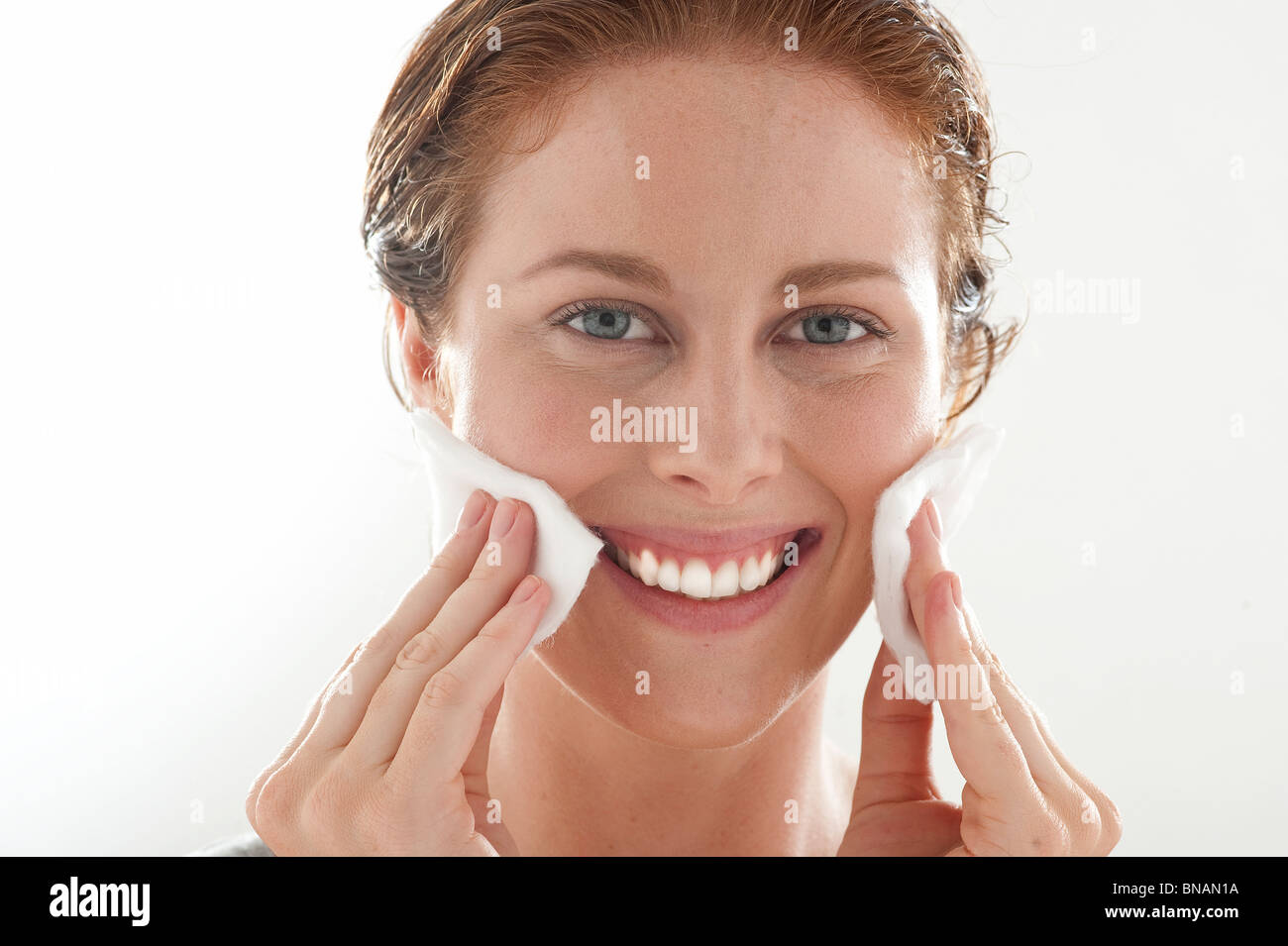 Woman wiping her face with a cotton wool pad Stock Photo - Alamy