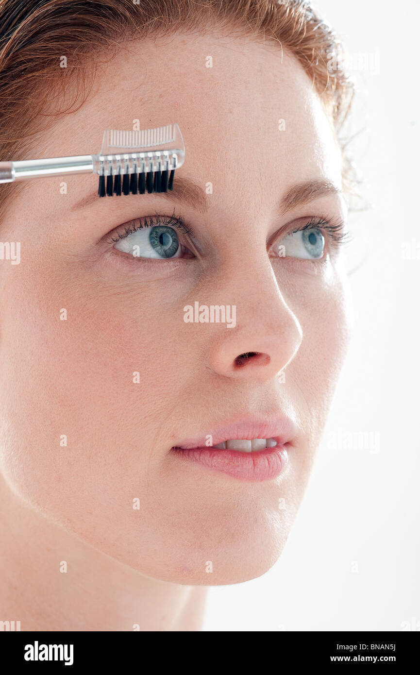 young woman brushing eyebrows Stock Photo - Alamy