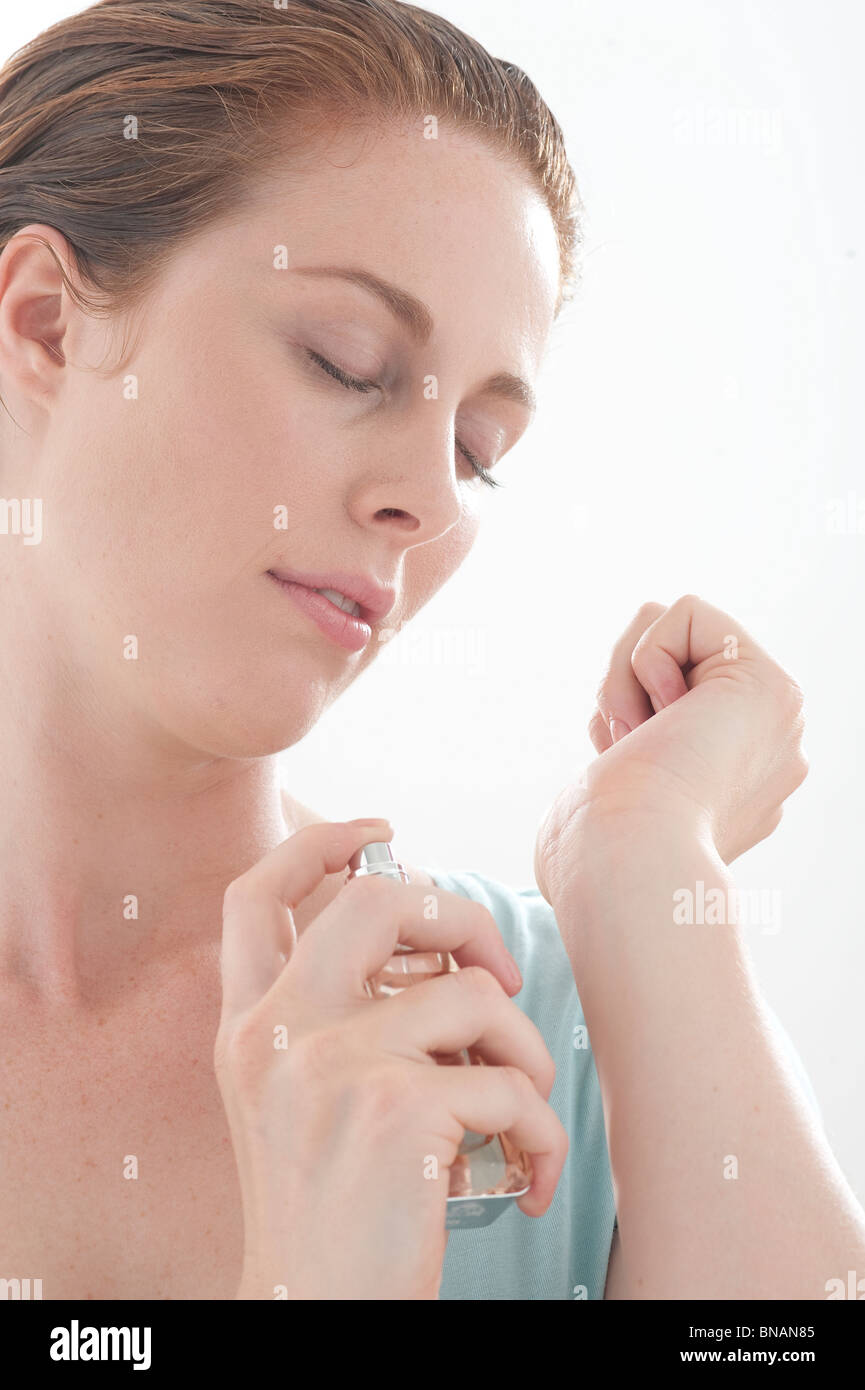 woman spraying perfume Stock Photo - Alamy