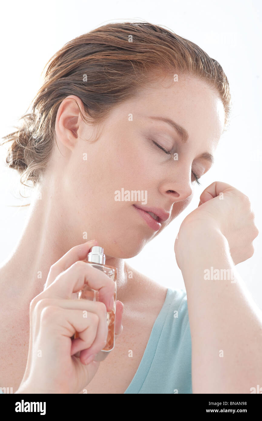 woman spraying perfume Stock Photo - Alamy