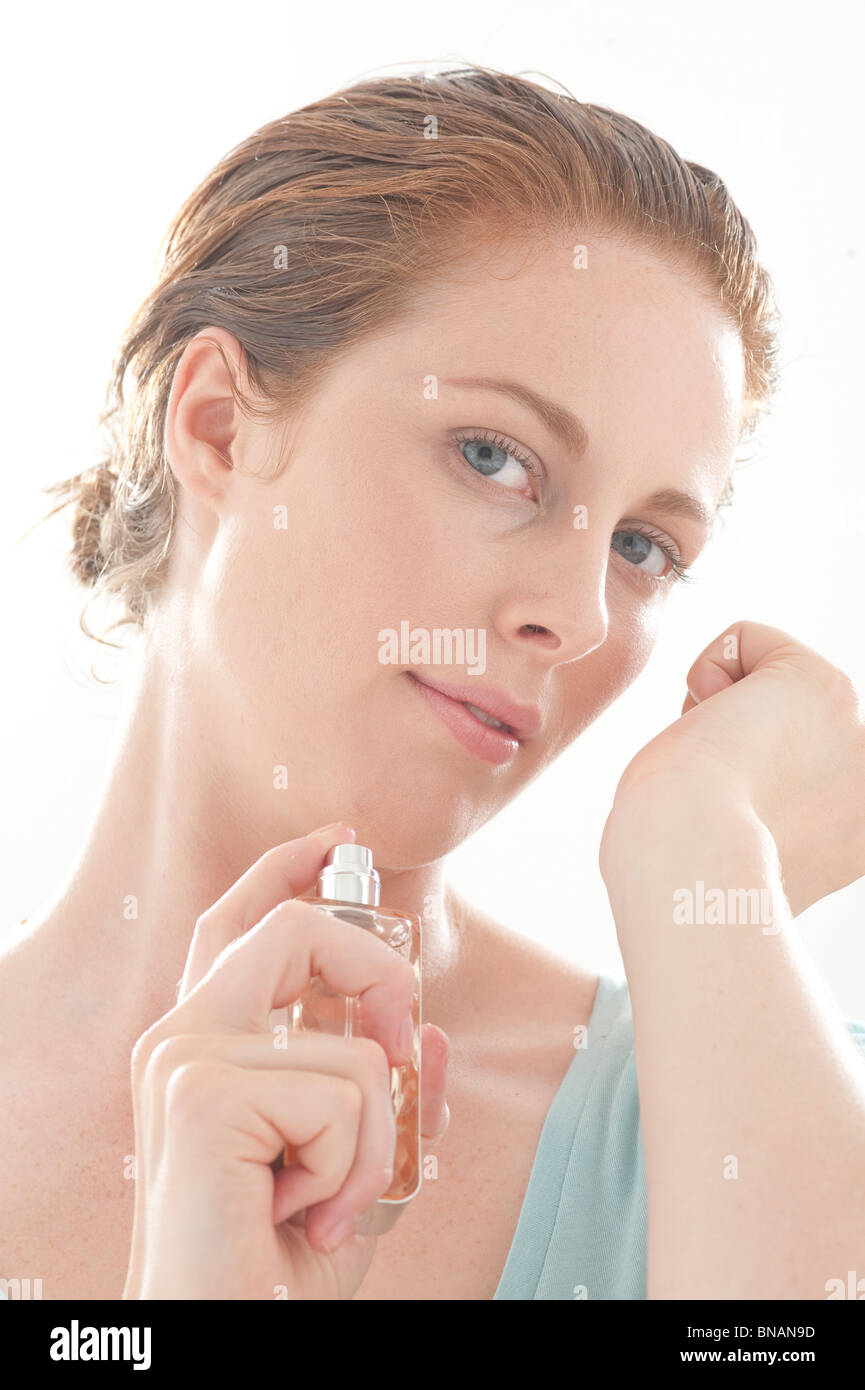 woman spraying perfume Stock Photo - Alamy