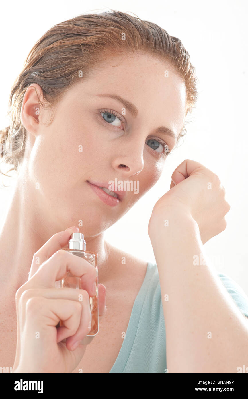 woman spraying perfume Stock Photo - Alamy