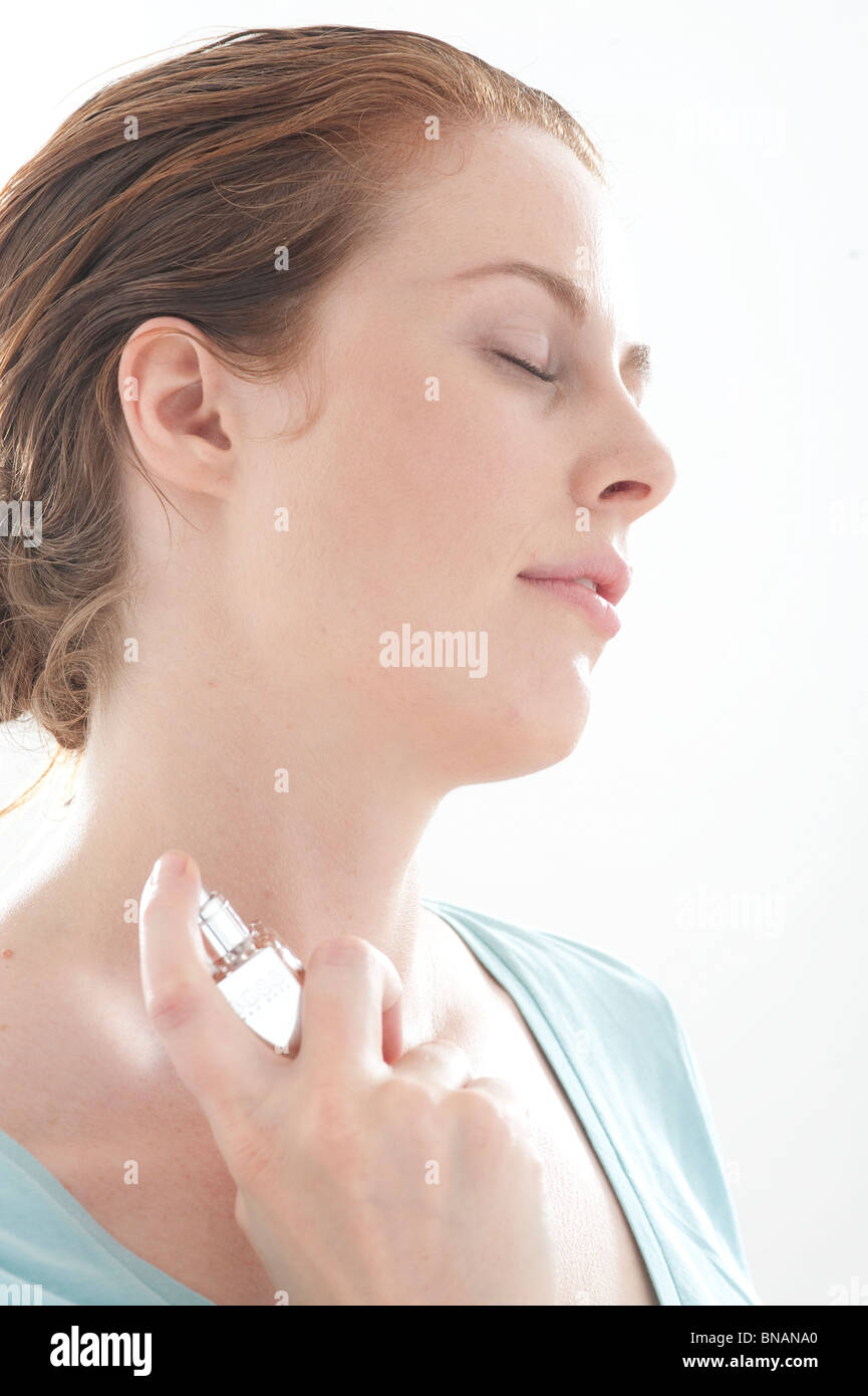 woman spraying perfume Stock Photo - Alamy