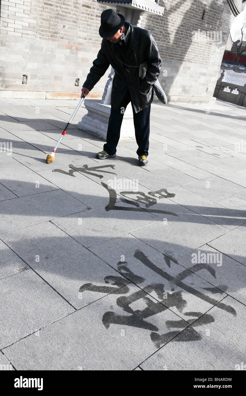 Visitors use the wide open spaces to practise their calligraphy with ...