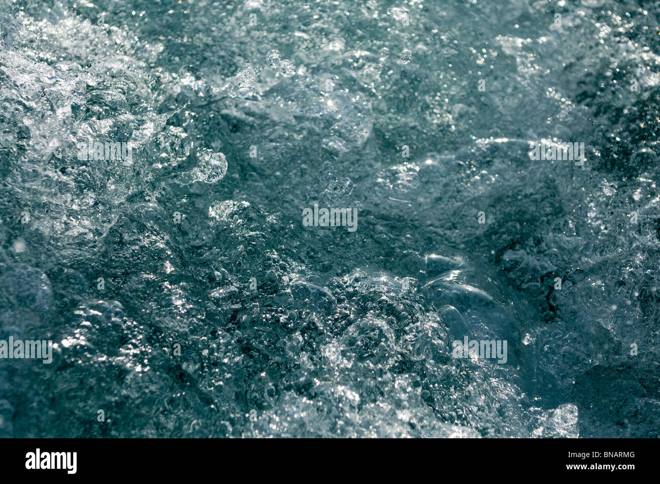 Frothy water thrown up in a boat's wake Stock Photo - Alamy