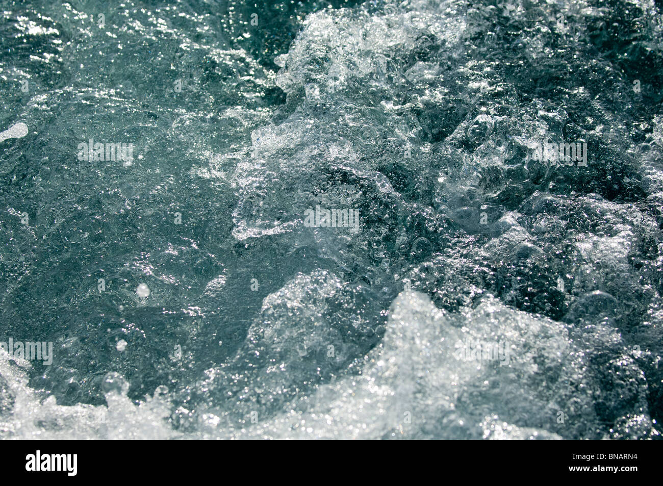 Frothy water thrown up in a boat's wake Stock Photo - Alamy