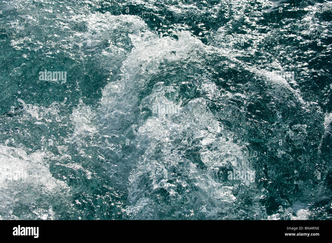 Frothy water thrown up in a boat's wake Stock Photo - Alamy