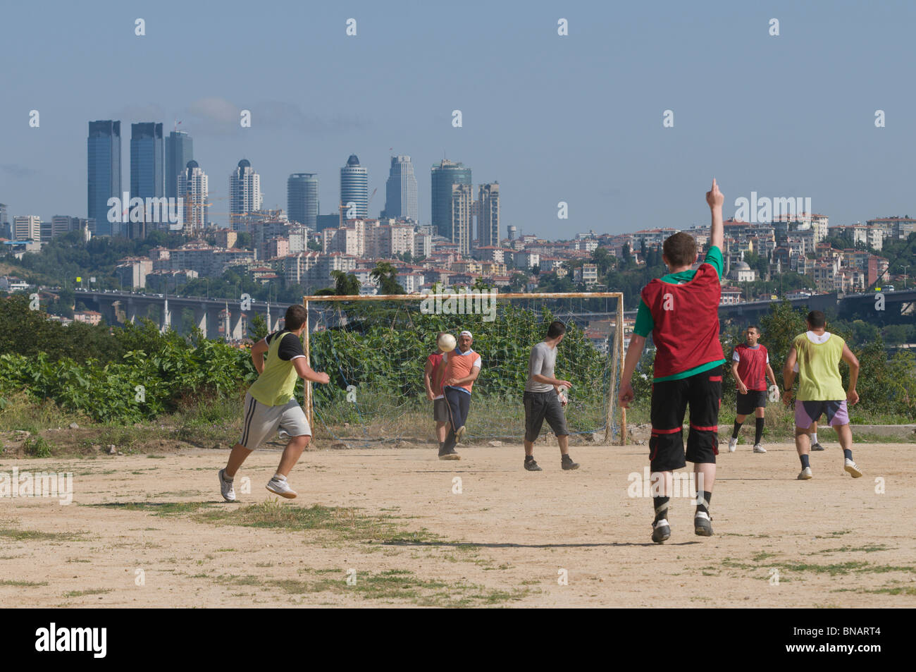 A football match ,the skyline of modern Istanbul in backround,Turkey ...