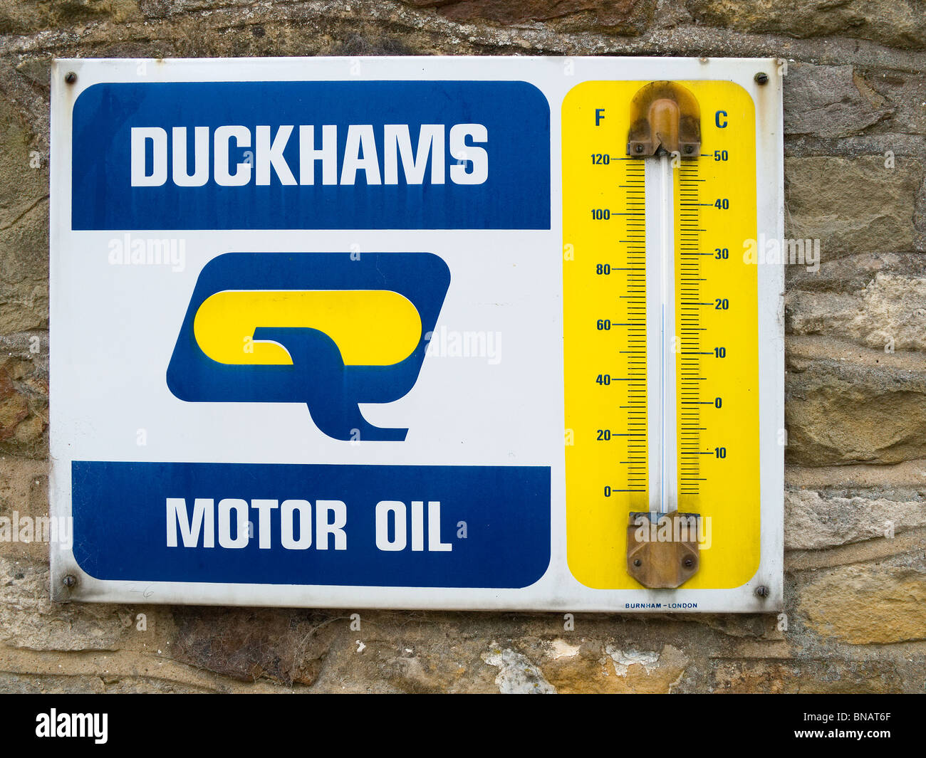 An old fashioned enamel sign for Duckhams "Q" Motor Oil with a ...