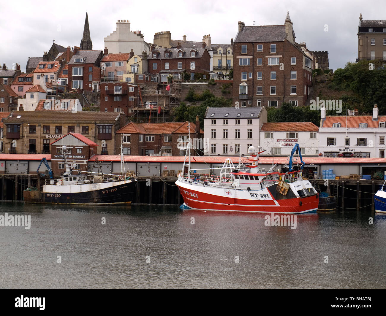 Two fishing boats one modern and the other old at Whitby fish quay ...