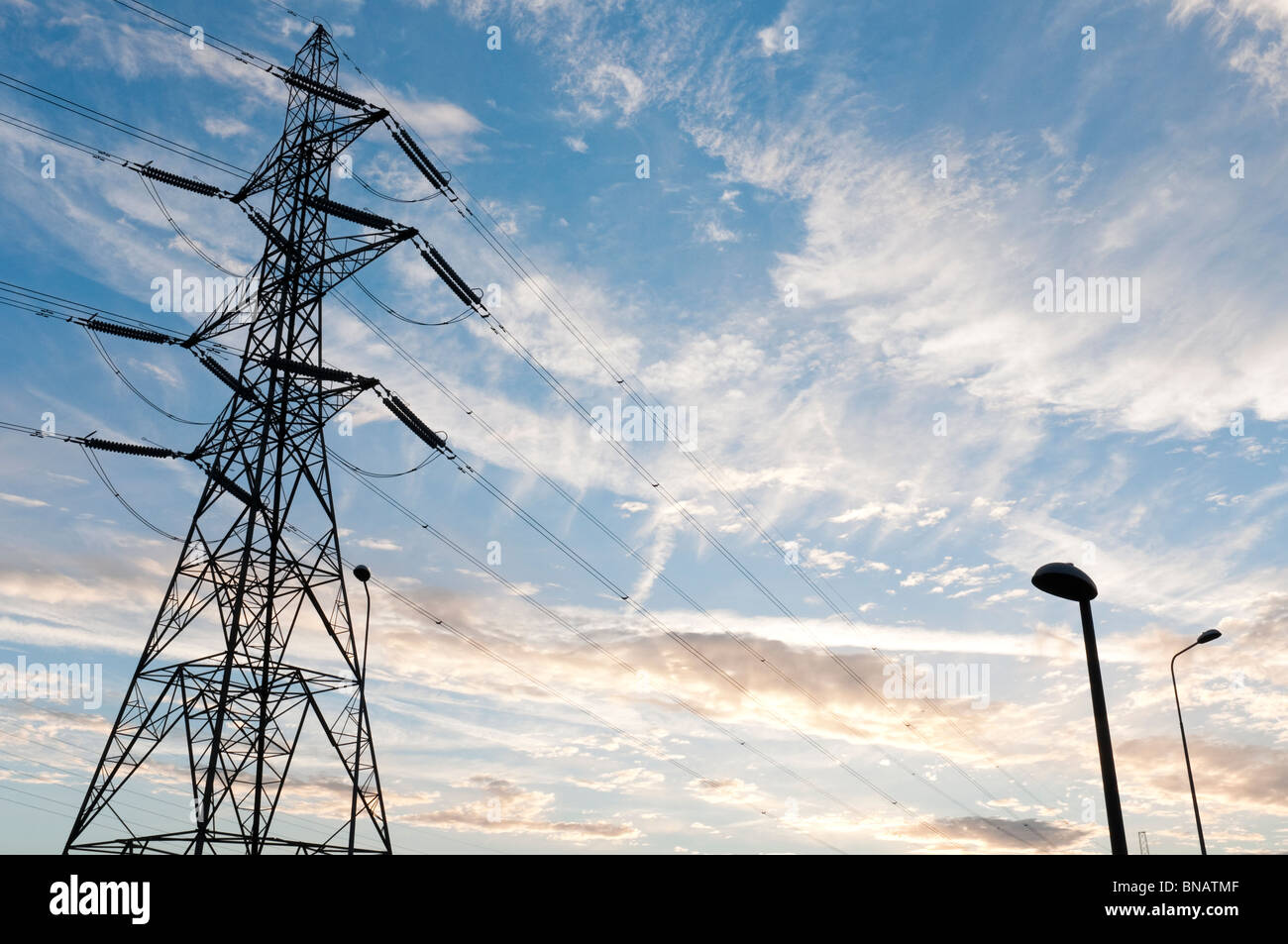 Low angle perspective shot of electric tower with at dusk Stock Photo ...