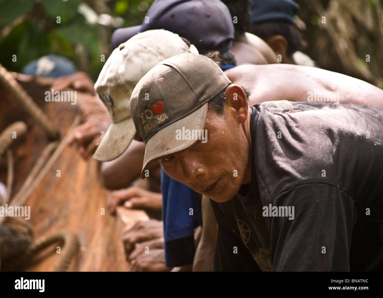 Kuna Indians haul a large ulu built in the rainforest on the mainland ...