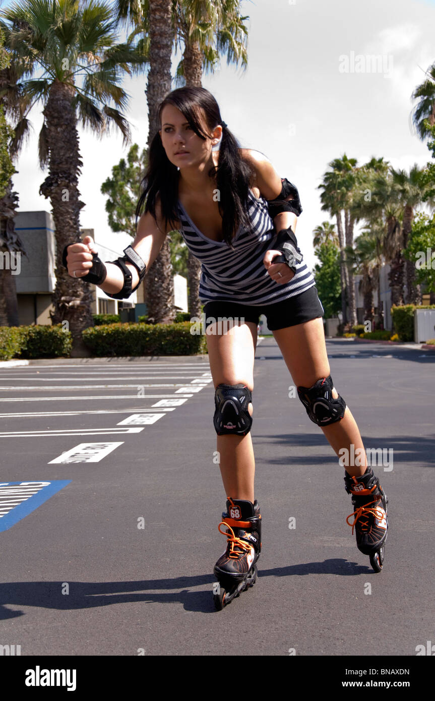 Young woman roller blading Stock Photo - Alamy