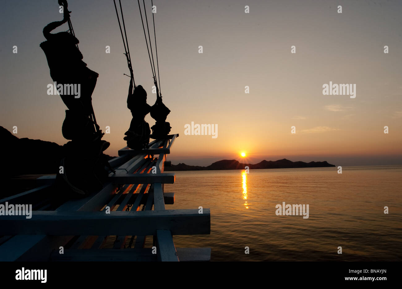 Sailing vessel at sunset Stock Photo - Alamy