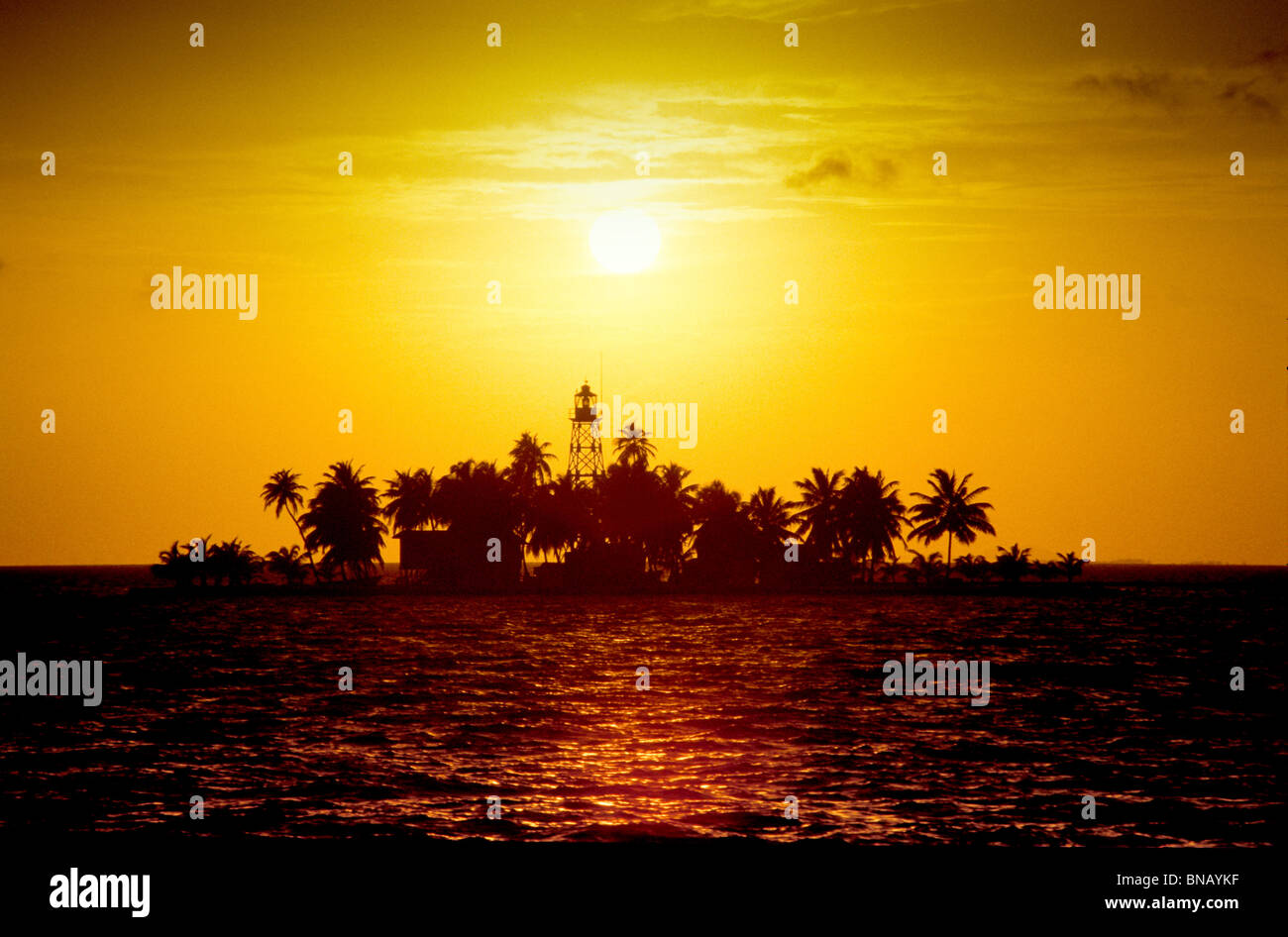 Sunset over island Stock Photo - Alamy