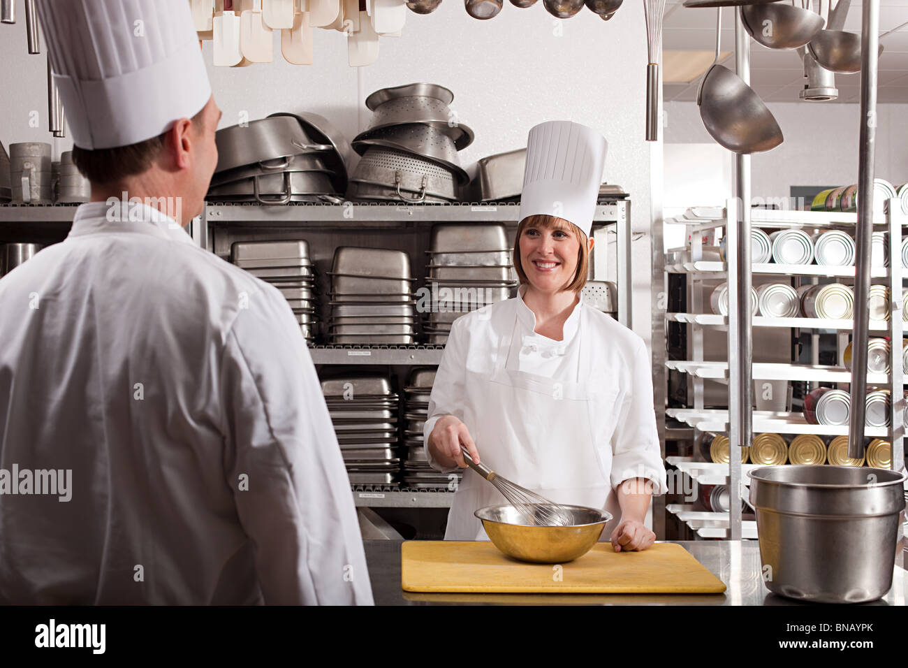 Chefs preparing food in commercial kitchen Stock Photo - Alamy