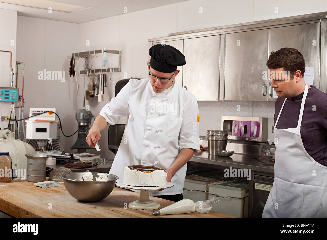 Chefs preparing food in commercial kitchen Stock Photo - Alamy
