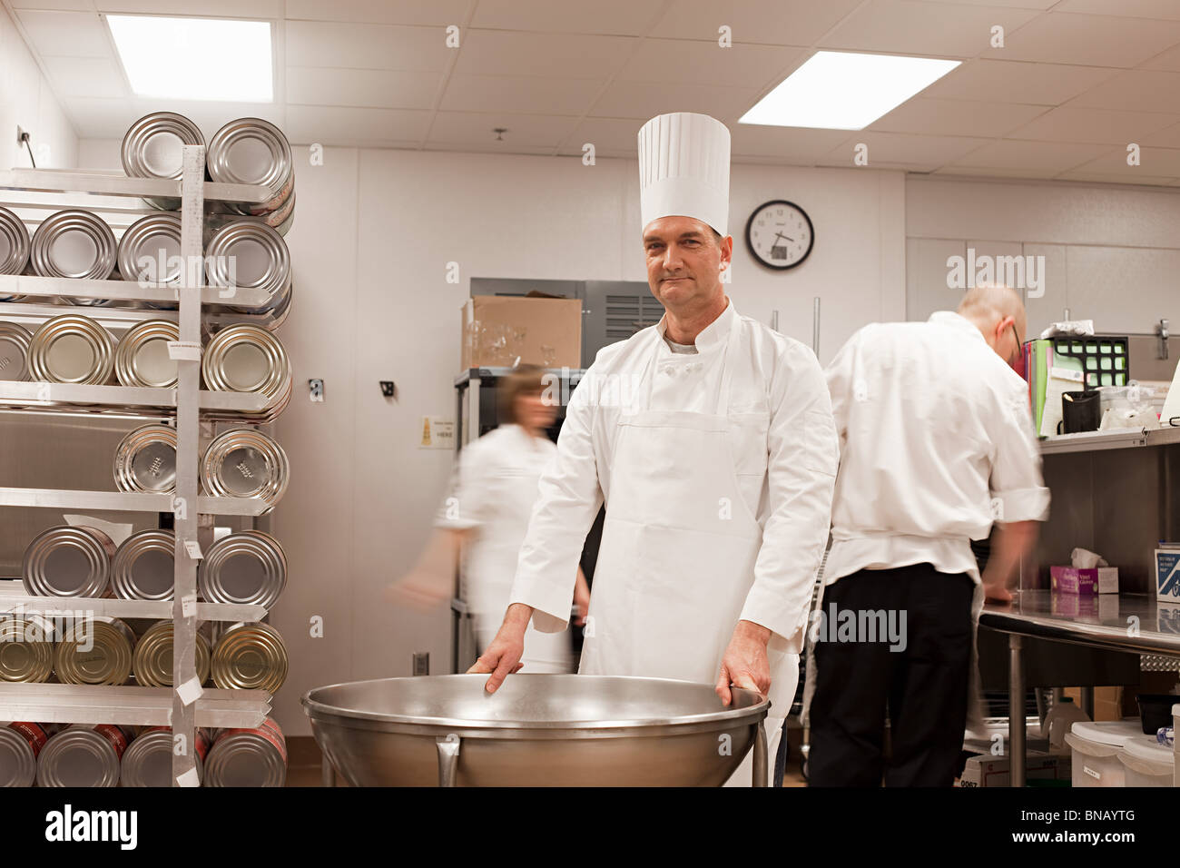 Chefs preparing food in commercial kitchen Stock Photo - Alamy