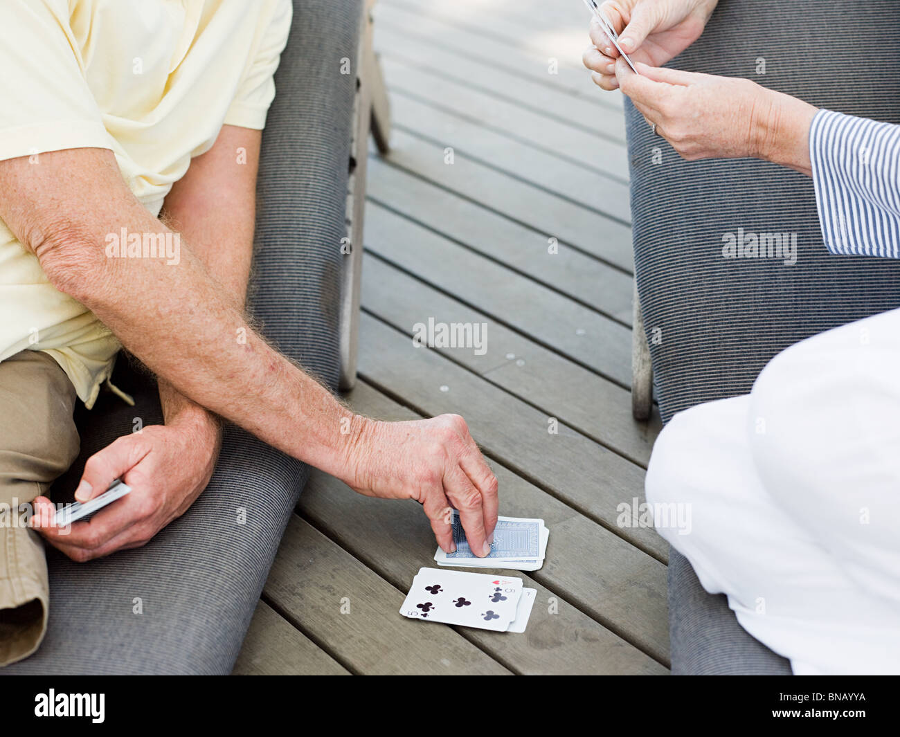 People playing cards outdoors Stock Photo - Alamy