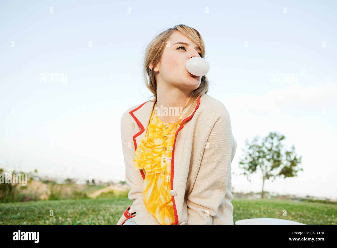 Young woman blowing bubble gum Stock Photo - Alamy