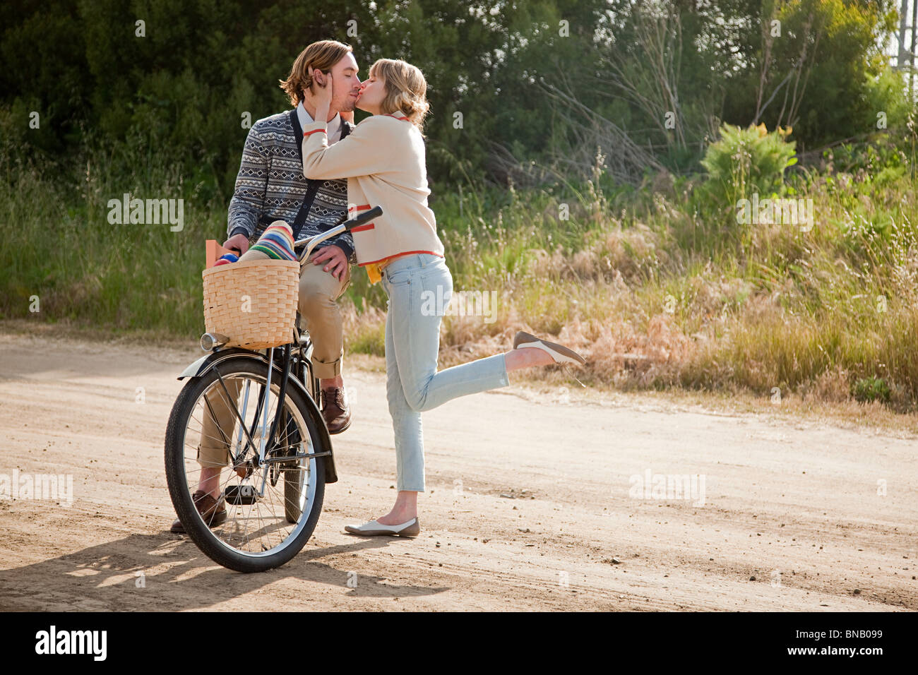 Kissing couple with bicycle Stock Photo - Alamy