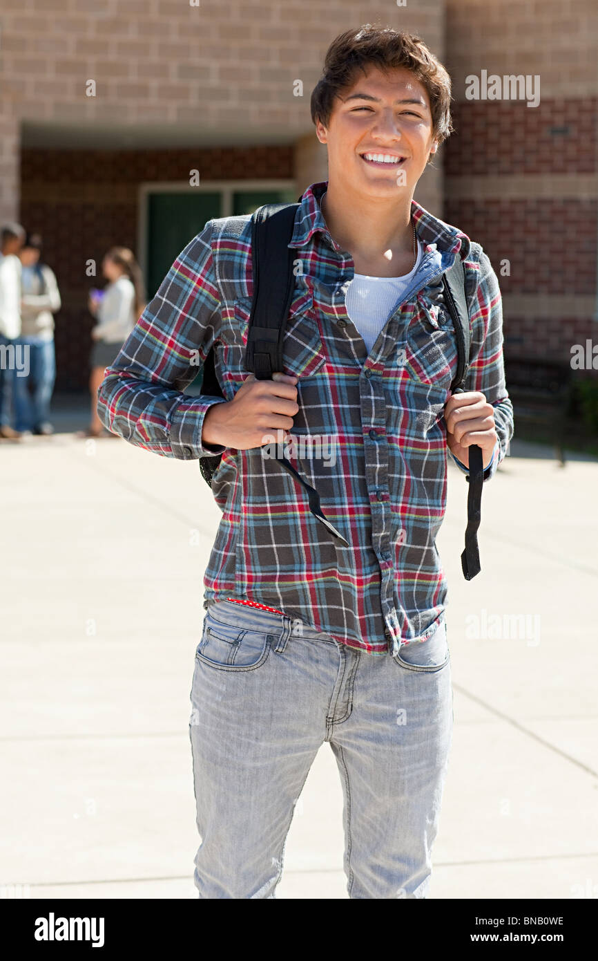 Male high school student outside school building Stock Photo - Alamy