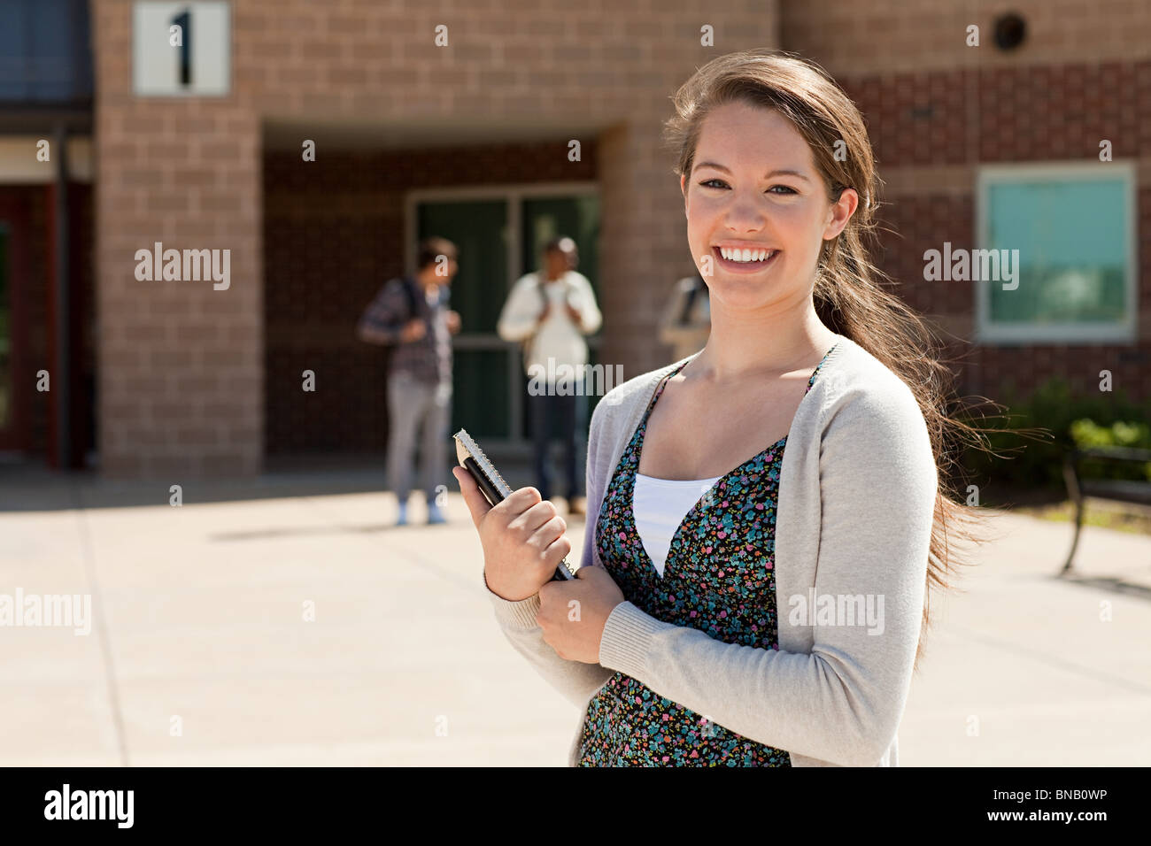 Female high school student outside school building Stock Photo - Alamy