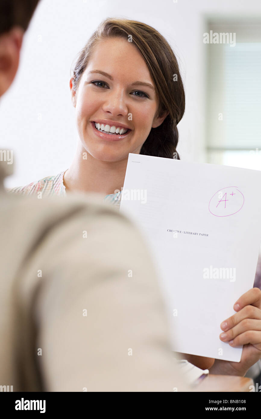 Successful female high school student holding assignment Stock Photo ...