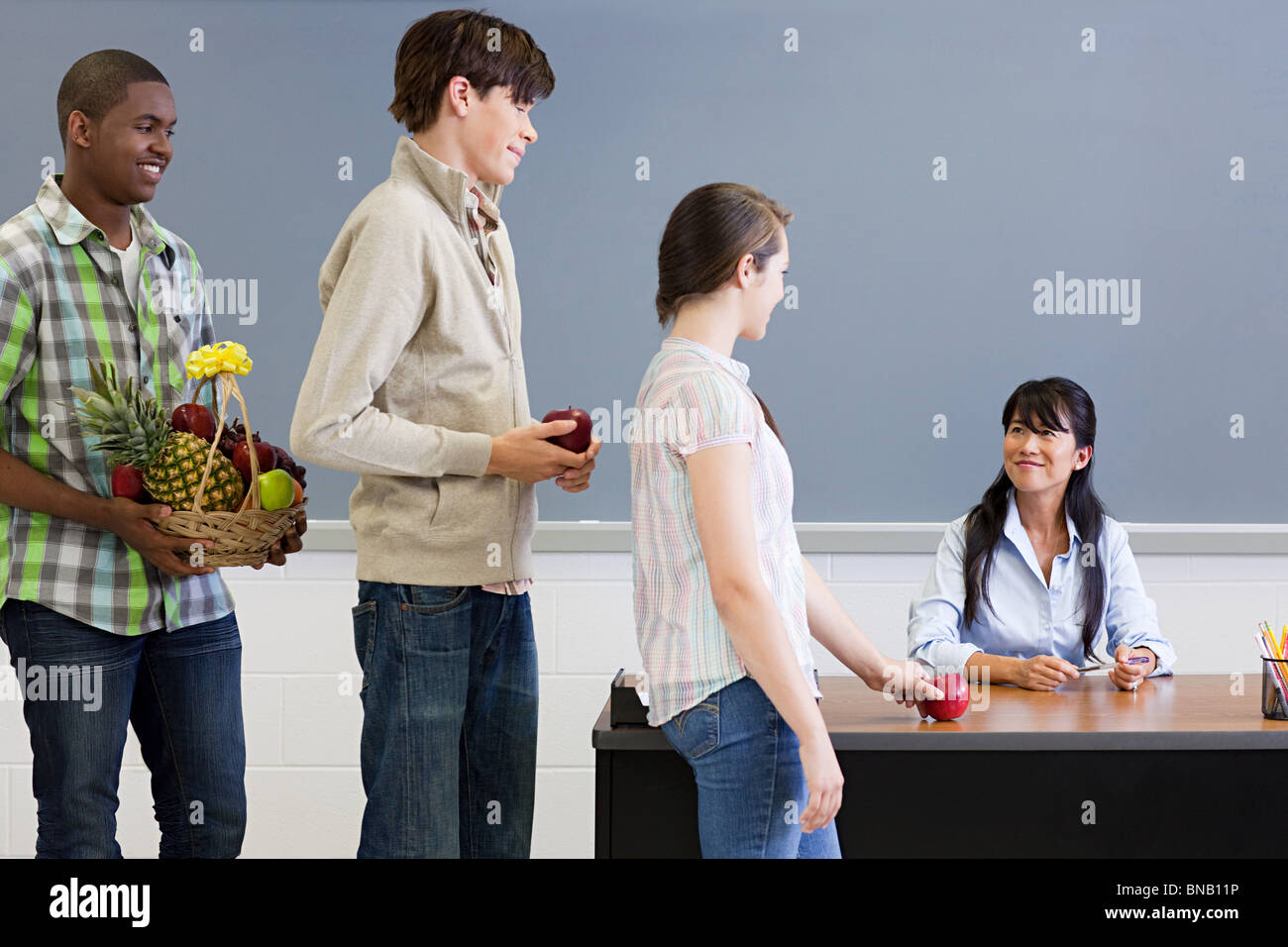 High school student giving teacher an apple Stock Photo - Alamy High school student giving teacher an apple Stock Photo - Alamy