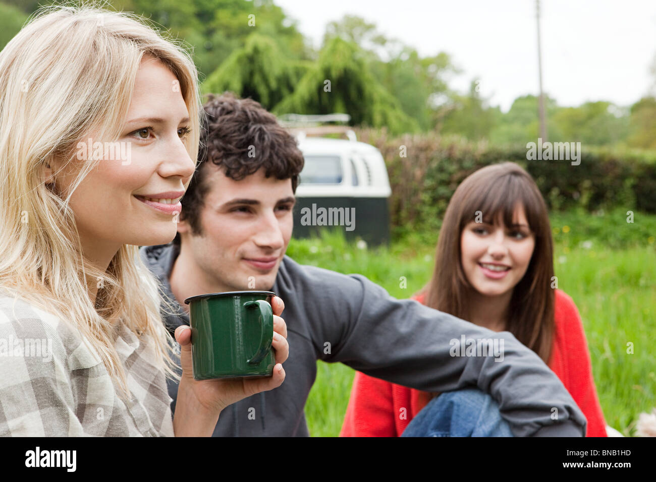 Young people in field Stock Photo - Alamy