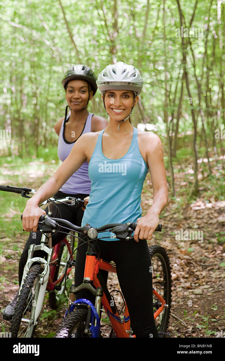 Two female cyclists in forest Stock Photo - Alamy