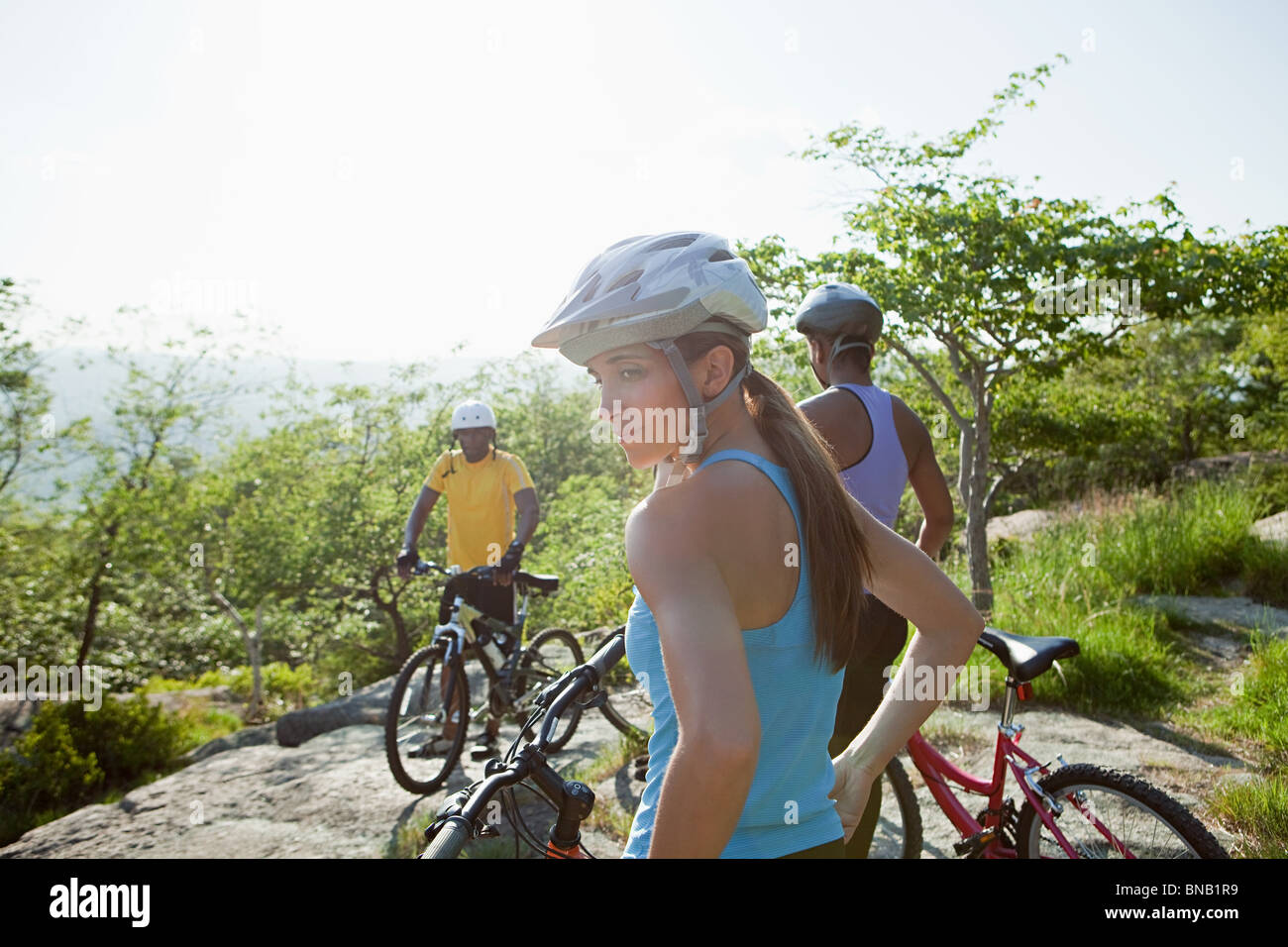 Three cyclists, rural scene Stock Photo - Alamy