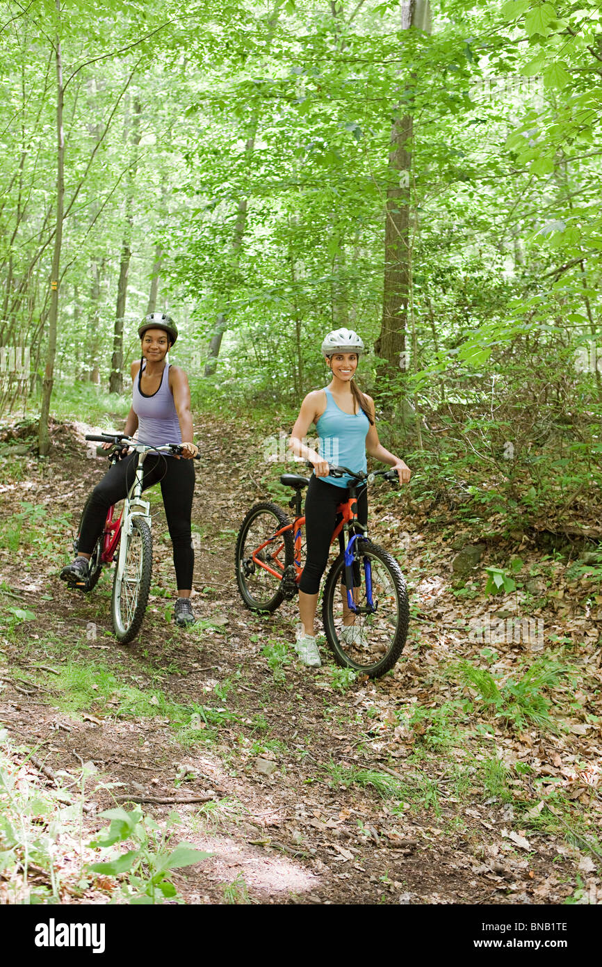 Two female cyclists in forest Stock Photo - Alamy