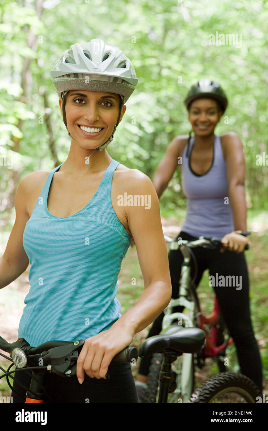 Two female cyclists in forest Stock Photo - Alamy