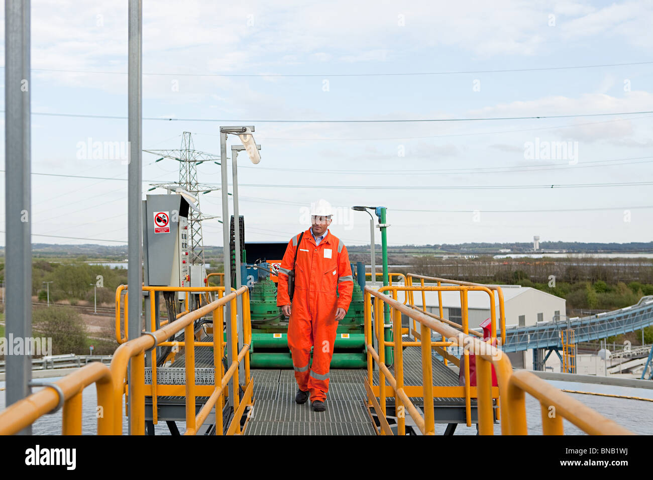 Engineer on walkway at industrial plant Stock Photo - Alamy