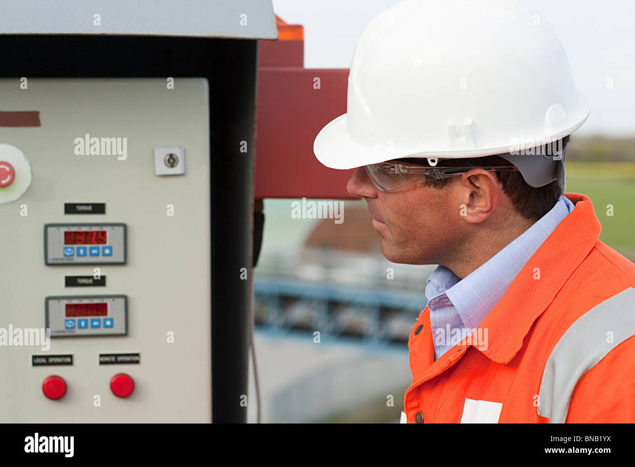 Engineer looking at control panel Stock Photo - Alamy